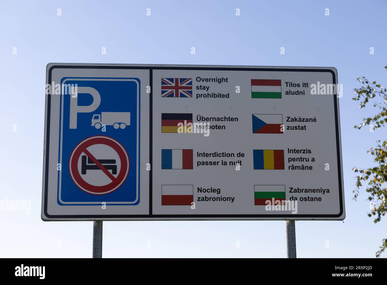 Road sign at truck parking with text "Overnight stay prohibited" in 8 ...