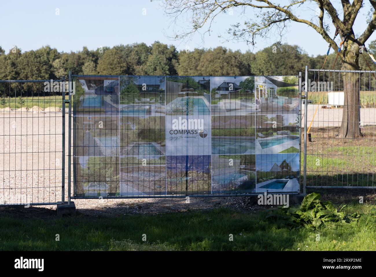 Commercial banner on a fence of Compass, a manufacturer of prefab pools ...