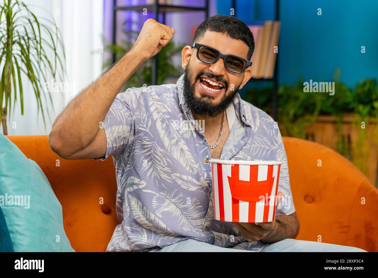 Indian man eating popcorn watching hi-res stock photography and images ...
