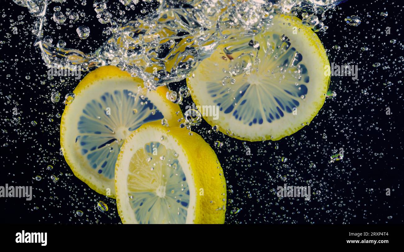 Underwater of freshly squeezed sweetened lemonade which raw lemons ...