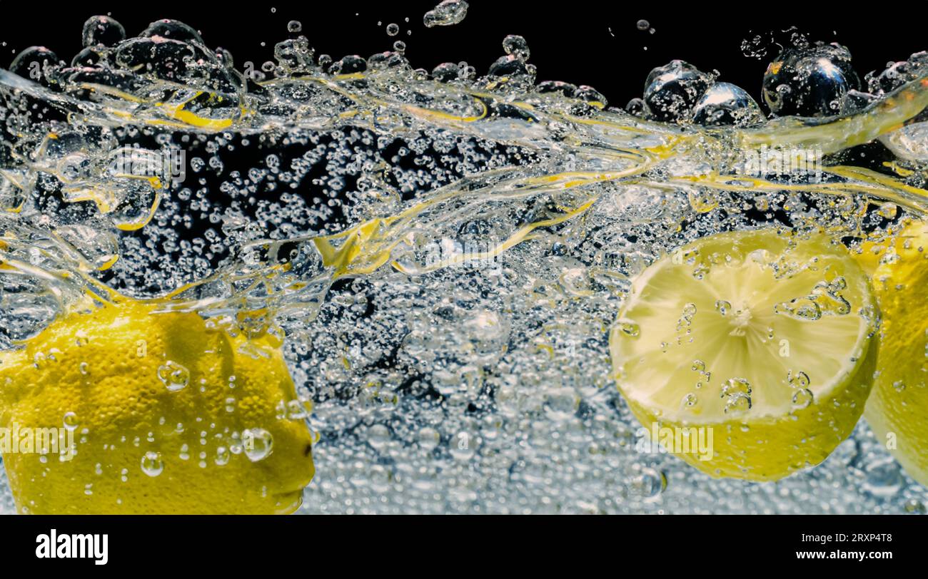 Underwater of freshly squeezed sweetened lemonade which raw lemons ...
