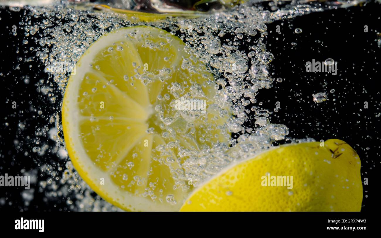 Underwater of freshly squeezed sweetened lemonade which raw lemons ...