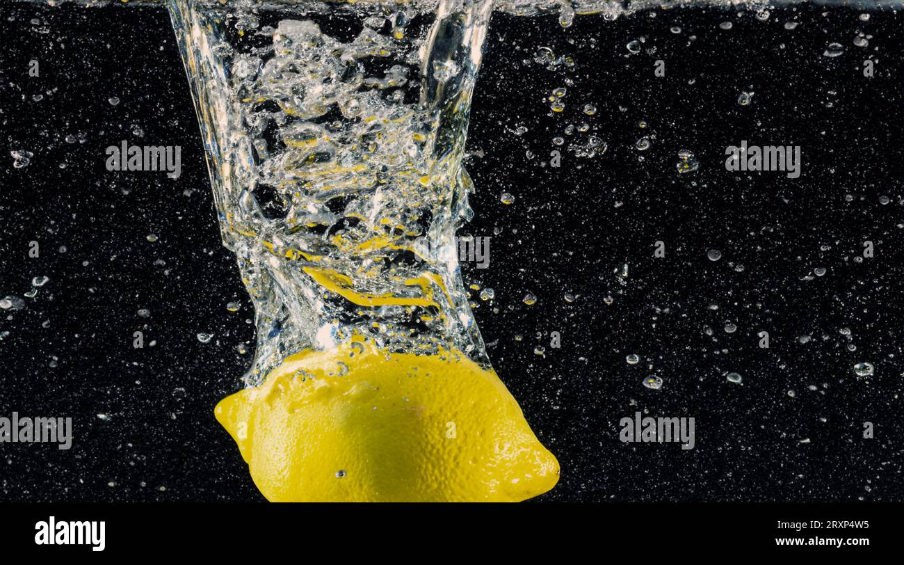 Underwater of freshly squeezed sweetened lemonade which raw lemons ...