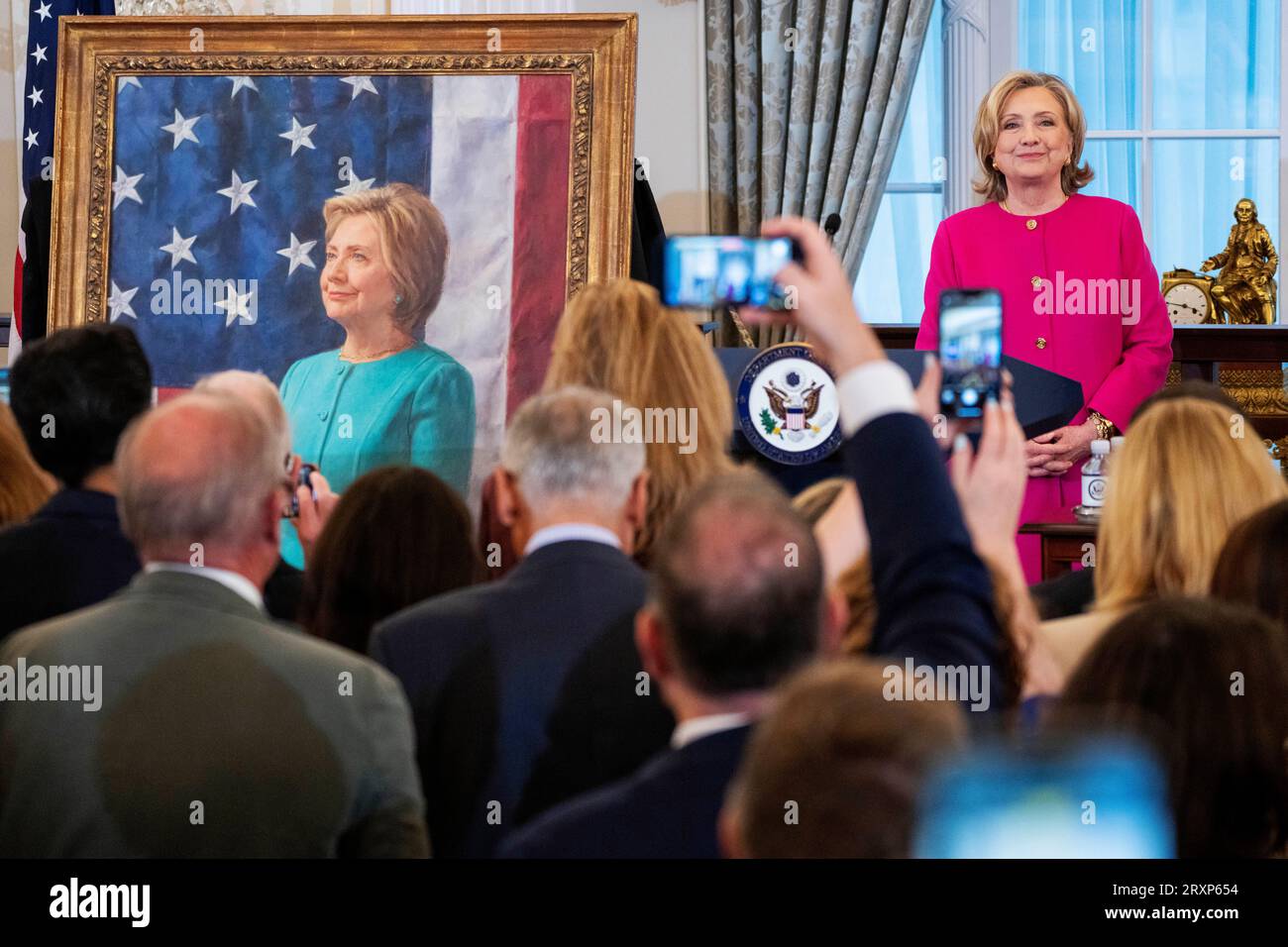 Former Secretary of State Hillary Rodham Clinton reacts as her portrait ...