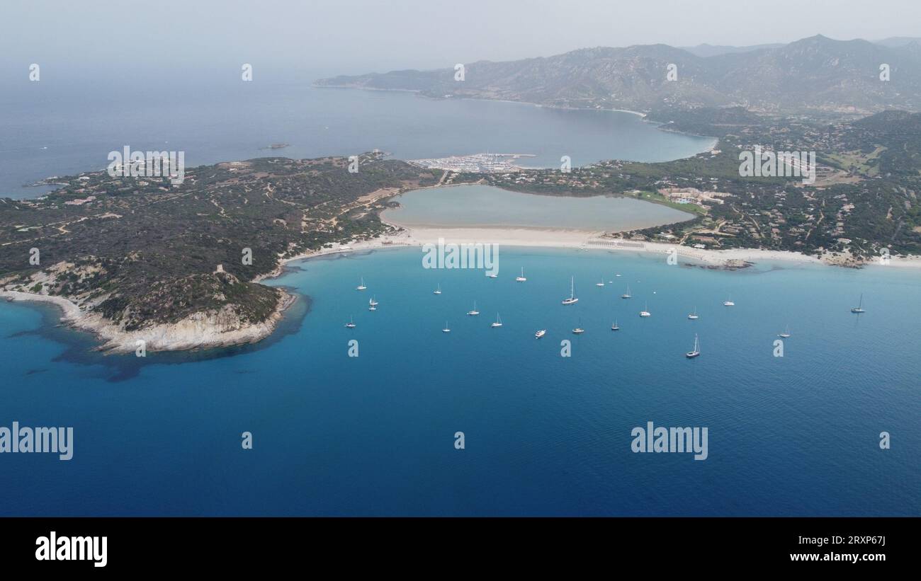 Areial view over boats anchored by Spiaggia Porto Guinco withStagno de ...