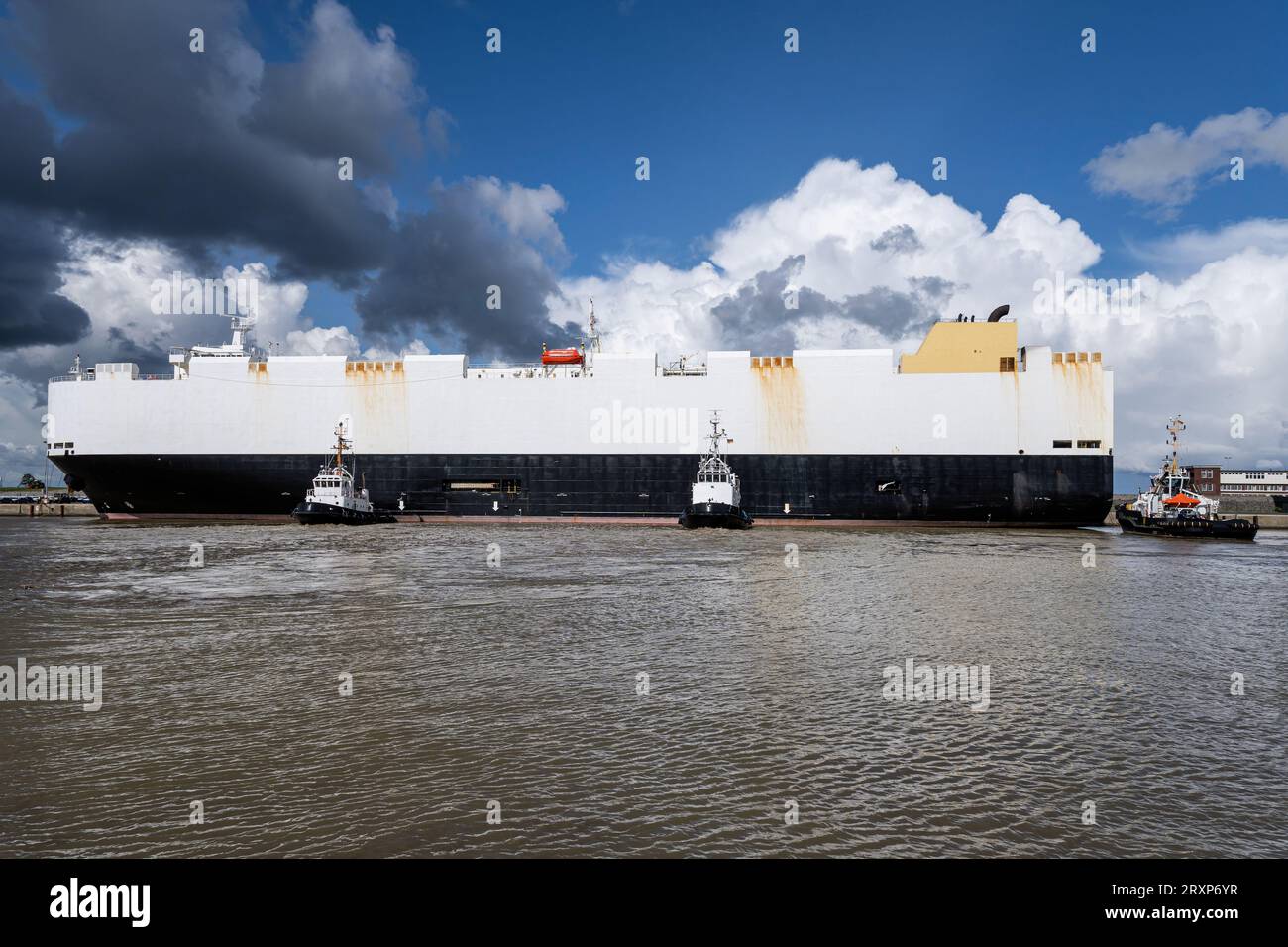 pure car and truck carrier assisted by tugs during docking maneuver ...