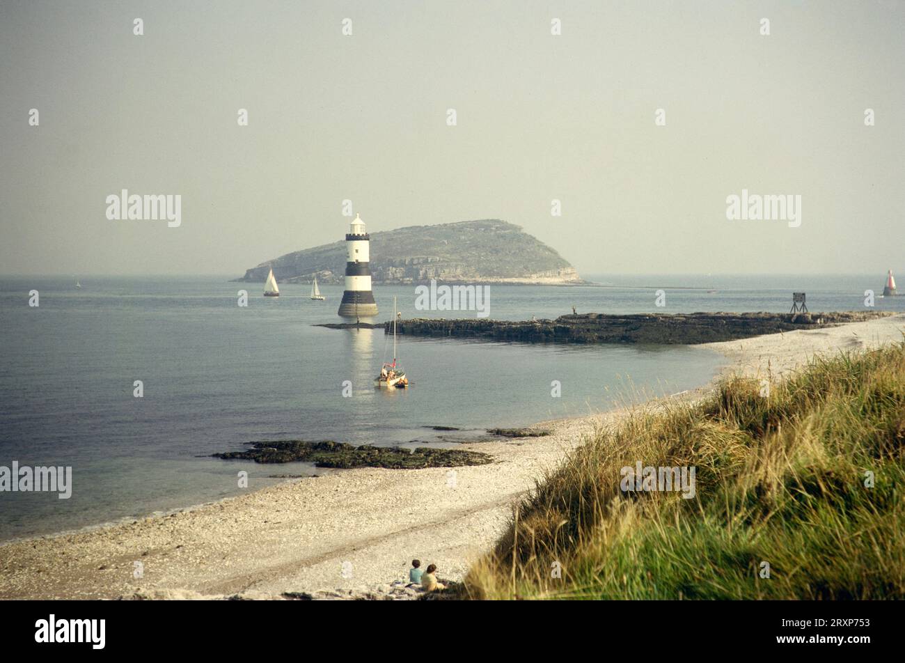 Yacht and lighthouse view to Priestholm, Puffin Island, Ynys Seiriol ...
