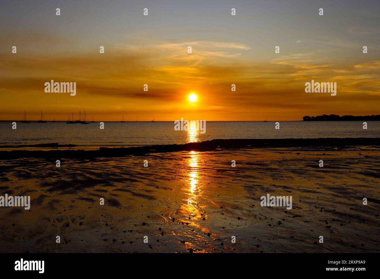 Sun setting at a beach in Darwin, Australia Stock Photo - Alamy