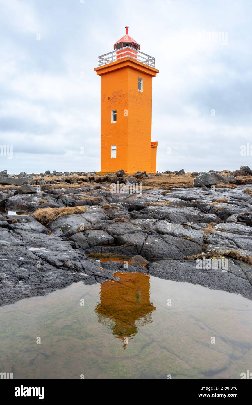 Orange lighthouse and his mirror picture Stock Photo - Alamy
