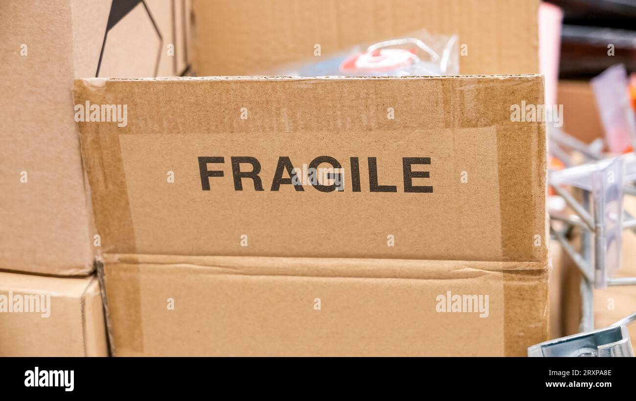 An open brown cardboard box with a FRAGILE label printed on it, opened ...