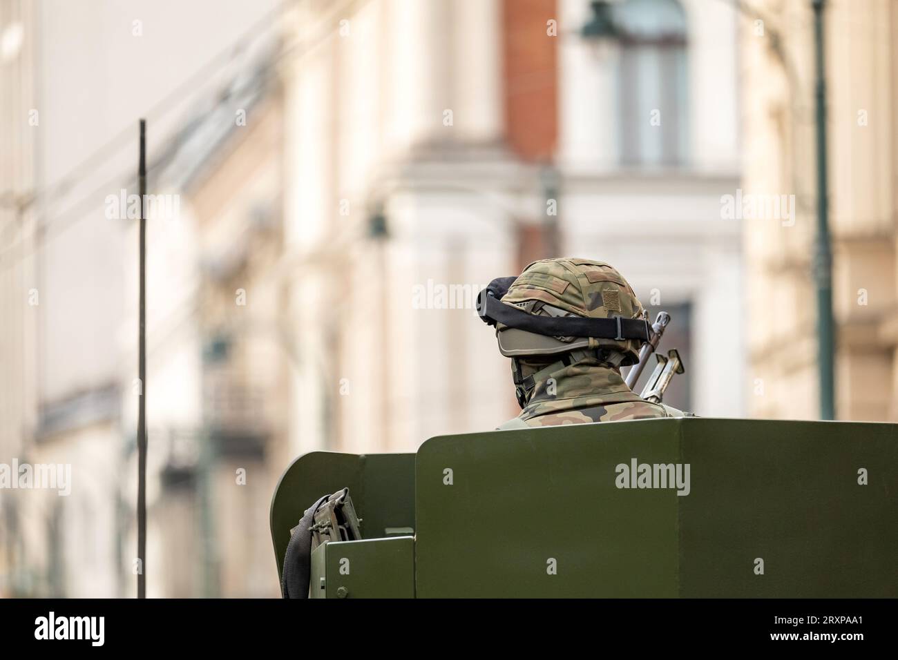 Anonymous unrecognizable generic soldier in an armored vehicle driving ...