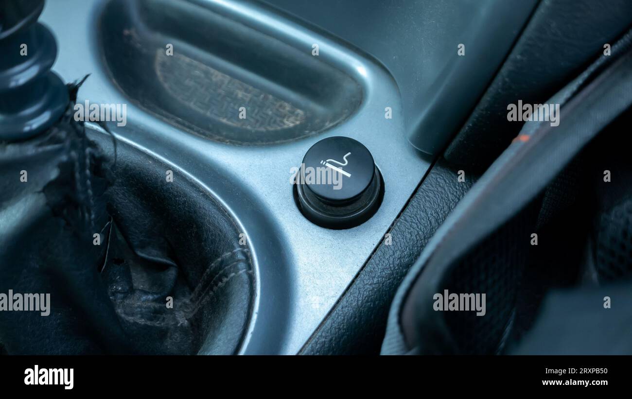 Electric cigarette lighter in an old worn dusty dirty car interior, car ...