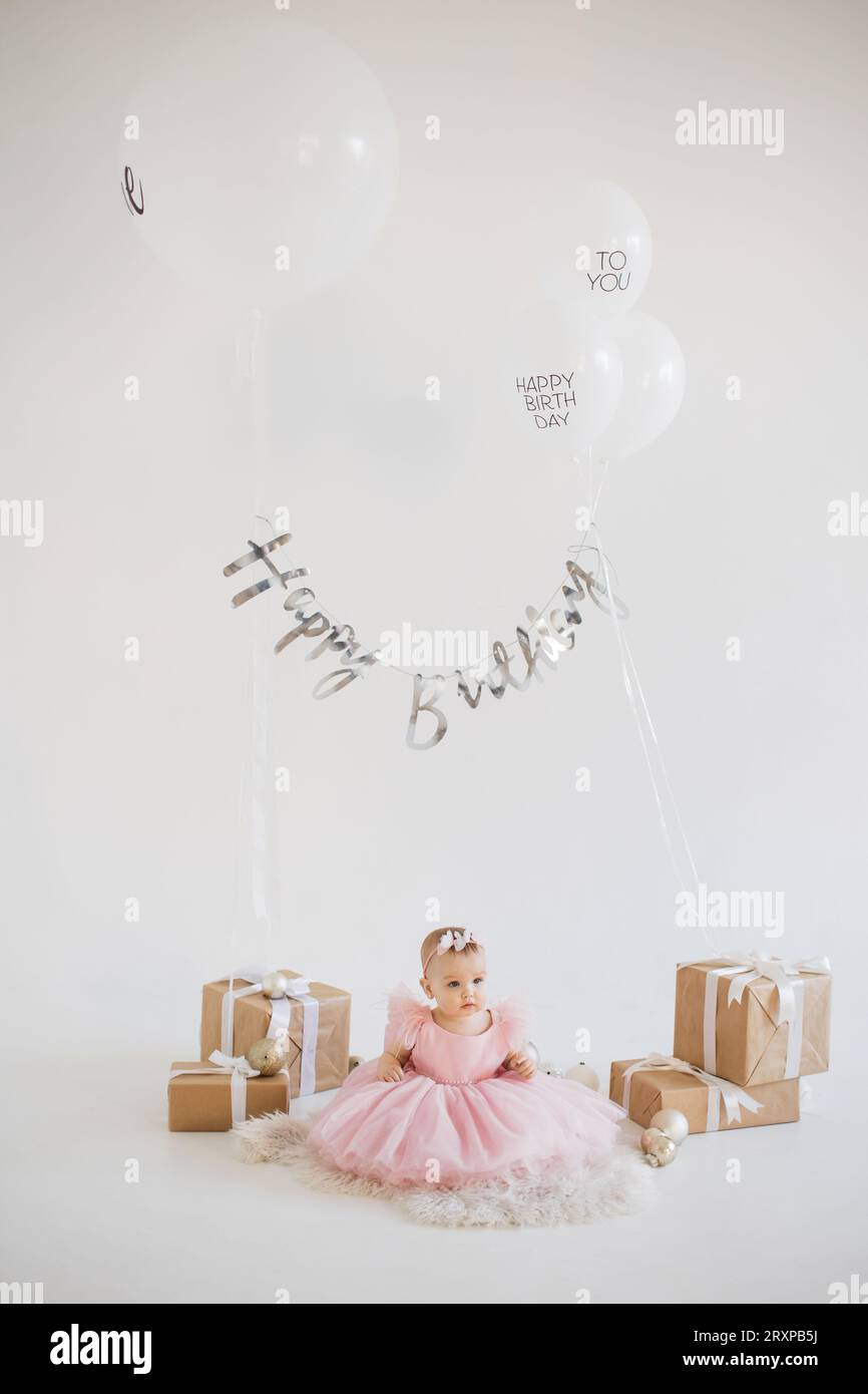 Little baby girl surrounded with birthday presents in studio Stock ...