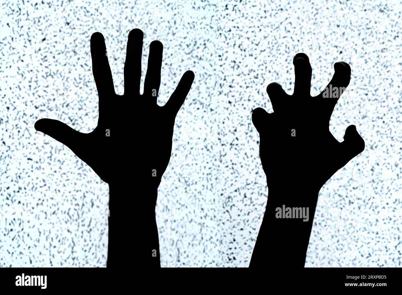 Two hands on a white noise TV screen background, black silhouettes ...