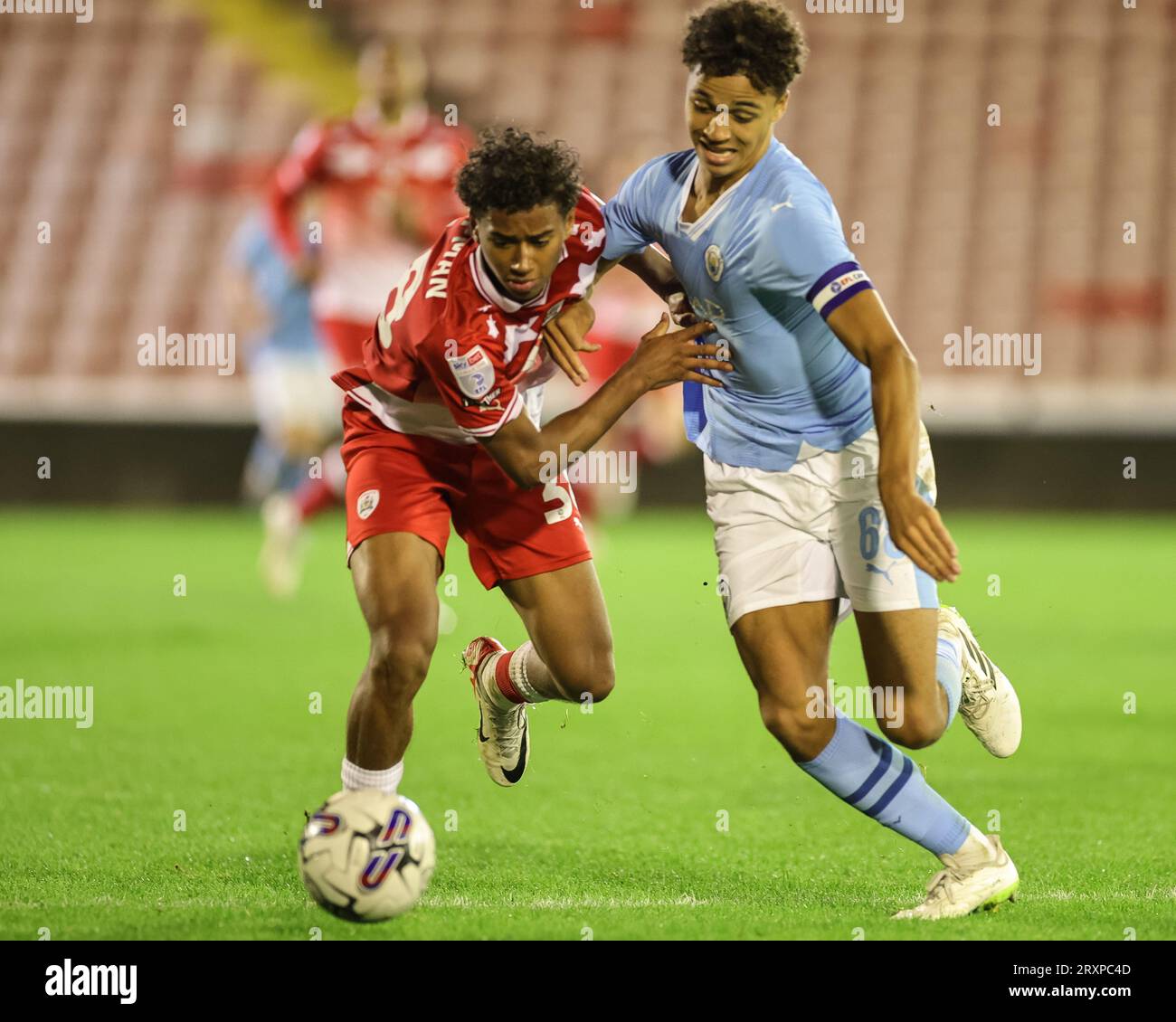 Barnsley, UK. 26th Sep, 2023. Theo Chapman #38 of Barnsley holds off ...
