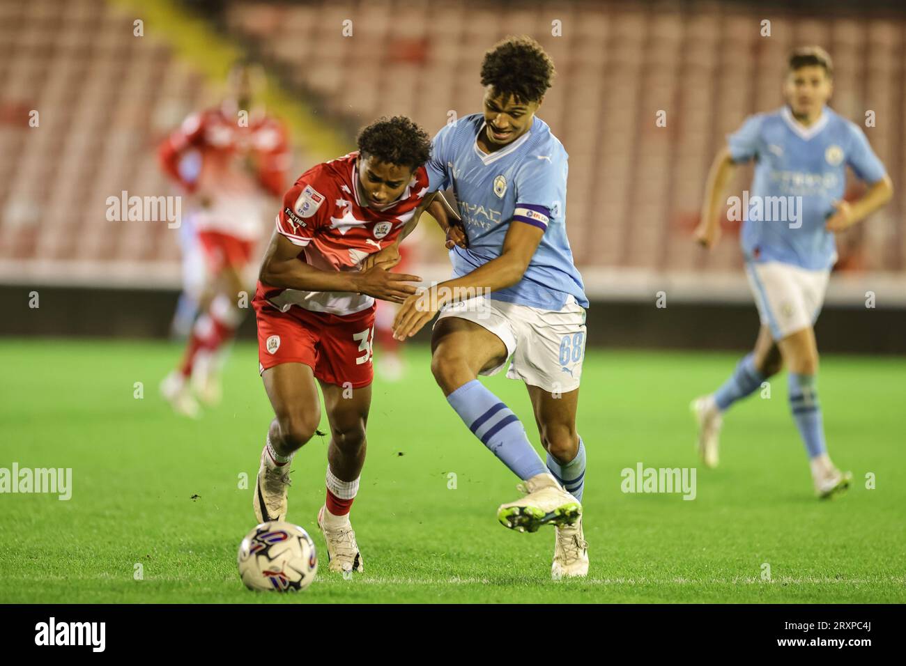 Barnsley, UK. 26th Sep, 2023. Theo Chapman #38 of Barnsley holds off ...