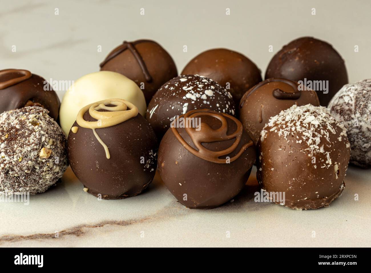 chocolate truffles of various flavors on a light background Stock Photo ...
