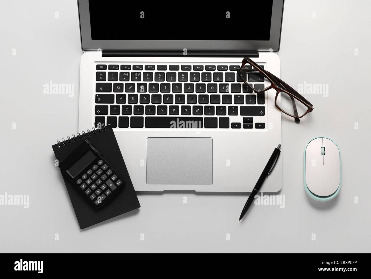 Composition with laptop, calculator and eyeglasses on white background ...