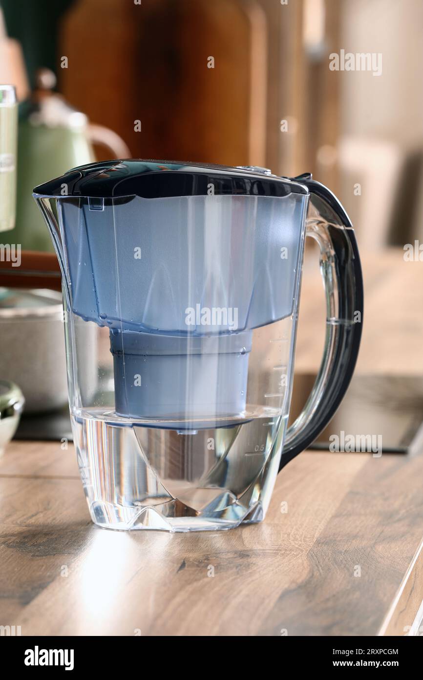 Modern filter jug on kitchen counter Stock Photo - Alamy