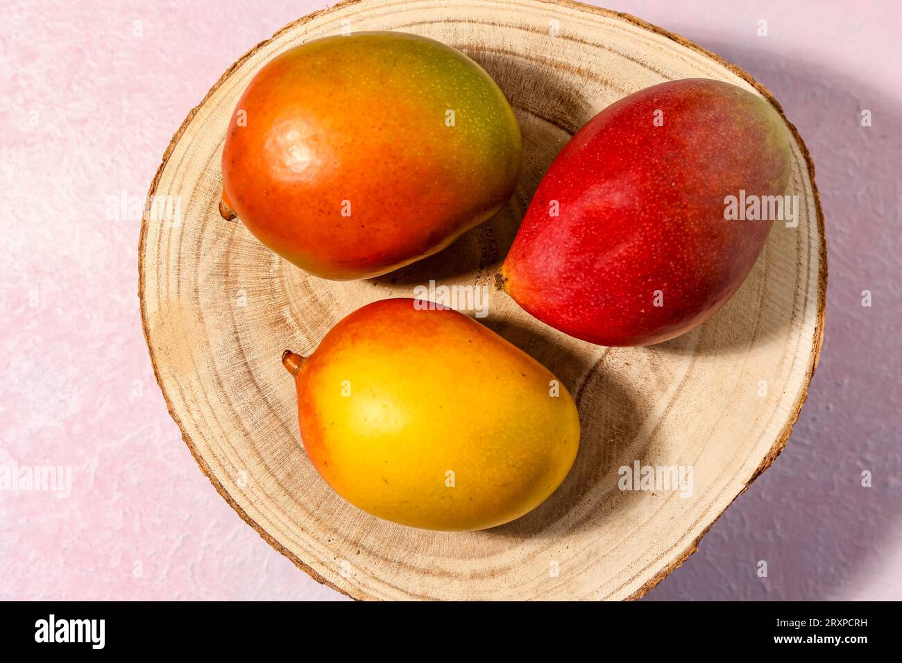 Fresh ripe mangoes on light background Stock Photo - Alamy