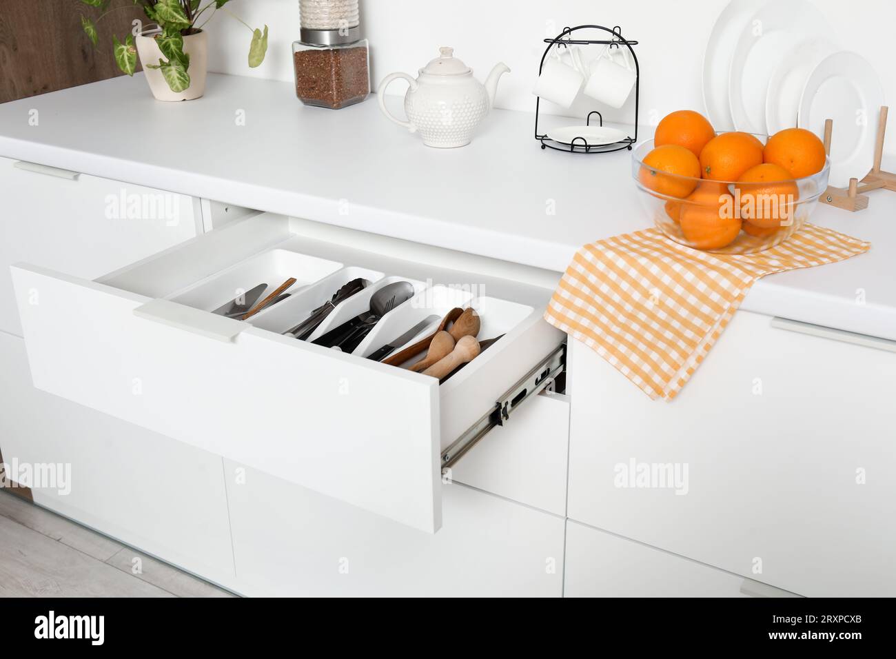 Open drawers with utensils in light kitchen Stock Photo - Alamy