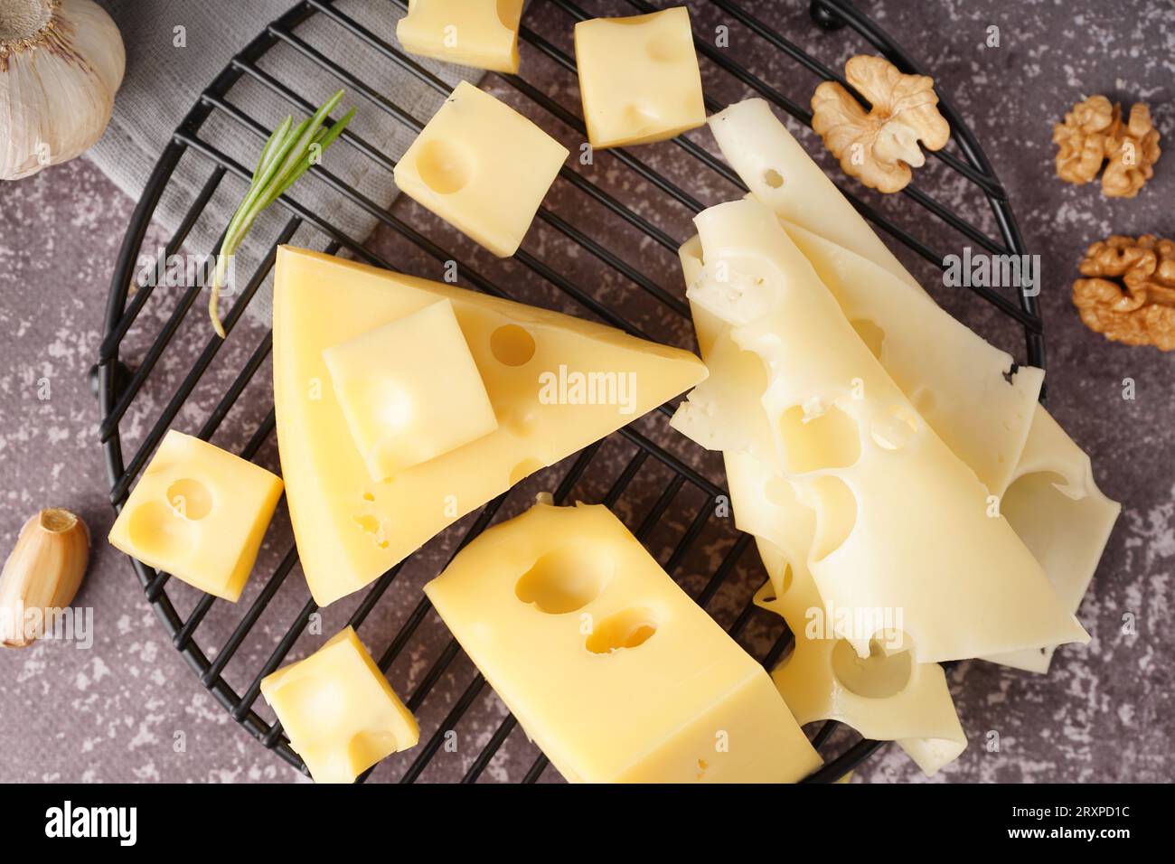 Stand with pieces of Swiss cheese and walnut on grey background Stock ...