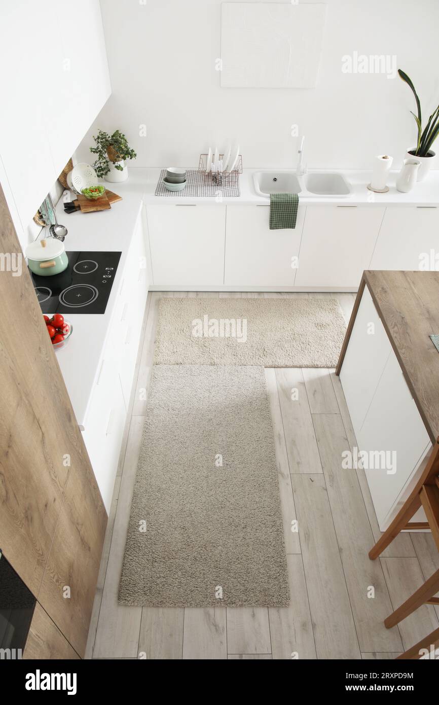 Soft rugs in interior of modern kitchen Stock Photo - Alamy