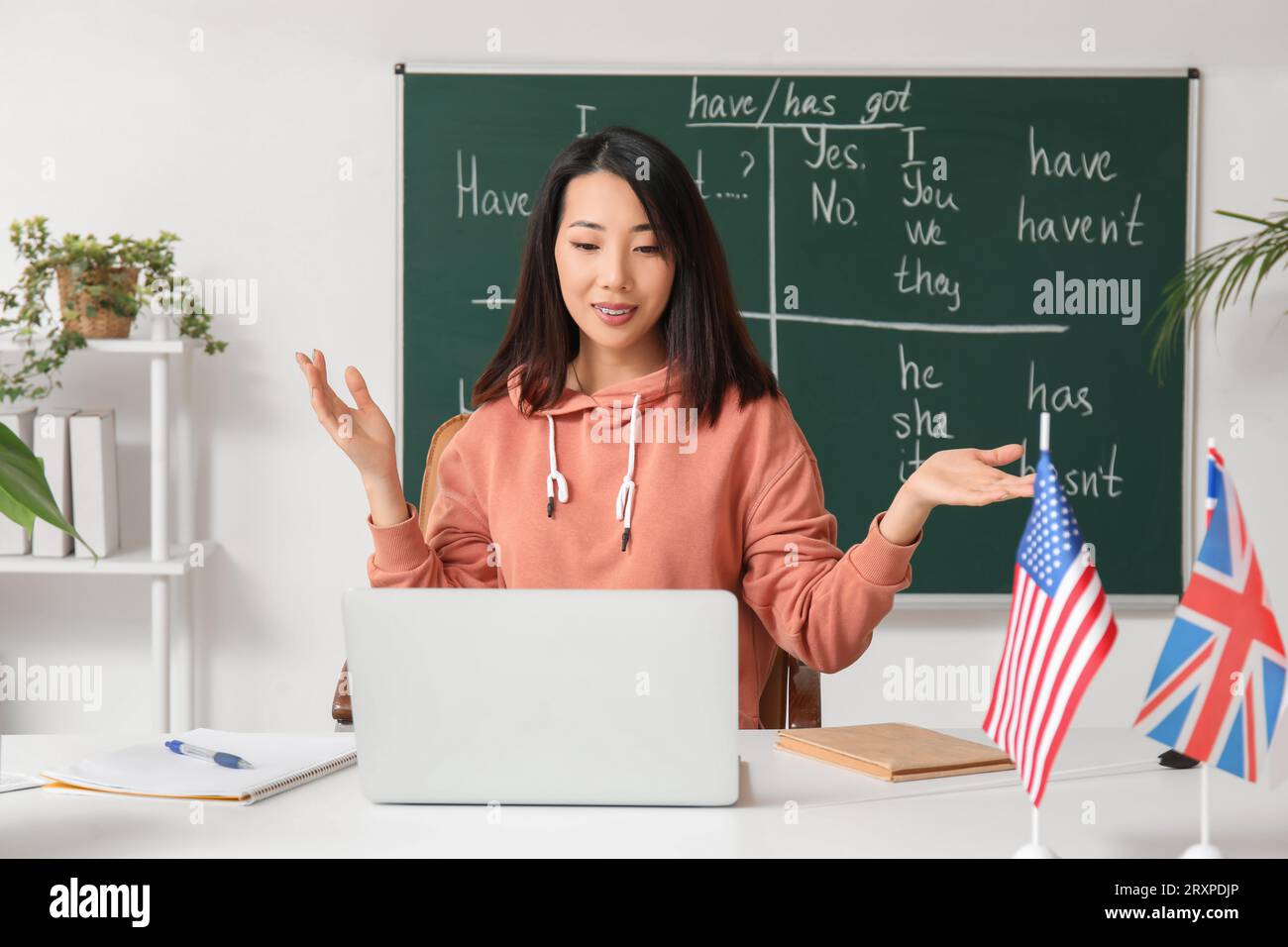 Female English teacher giving online grammar lesson in classroom Stock ...
