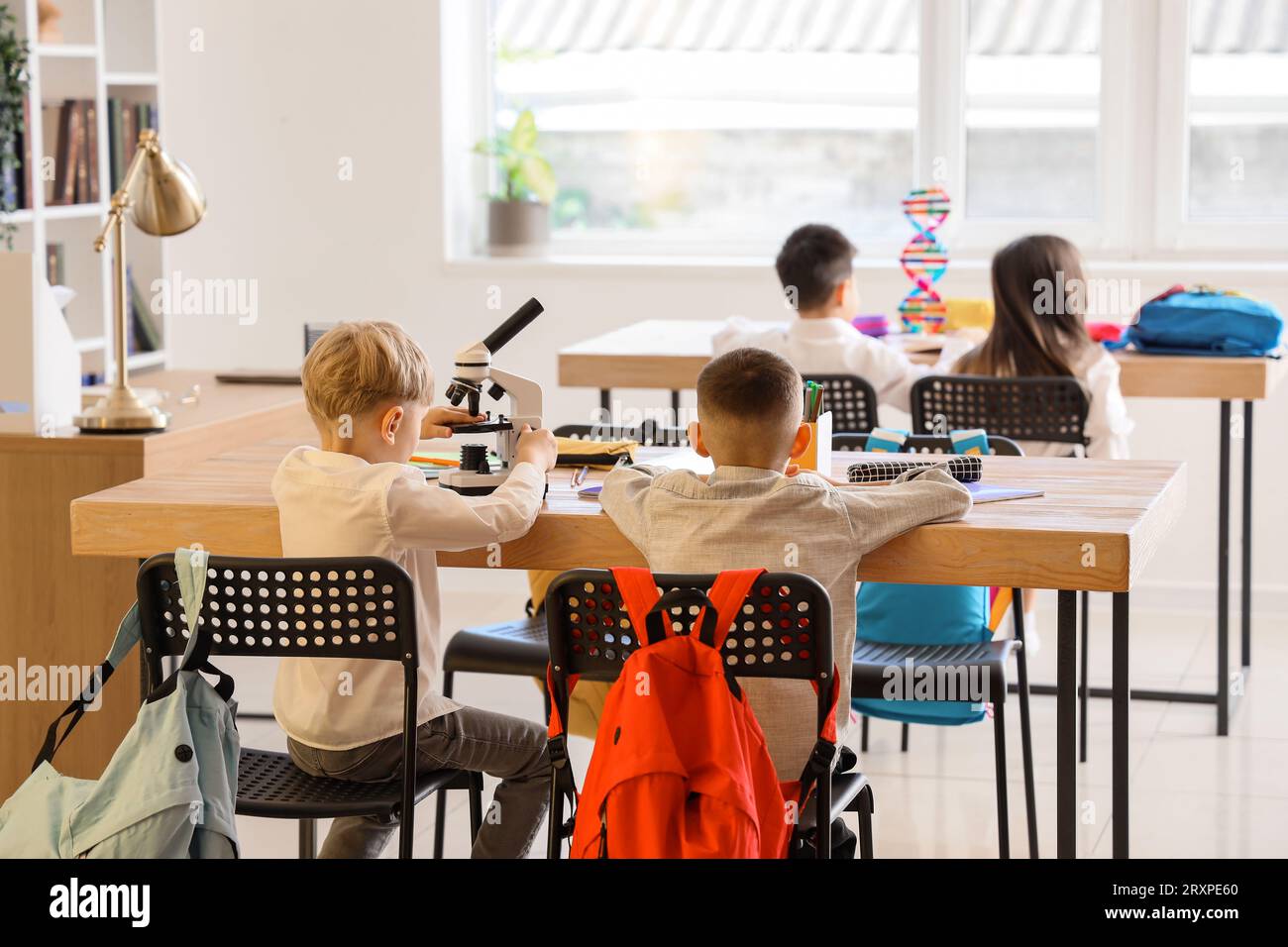 Little school children in classroom during lesson Stock Photo - Alamy