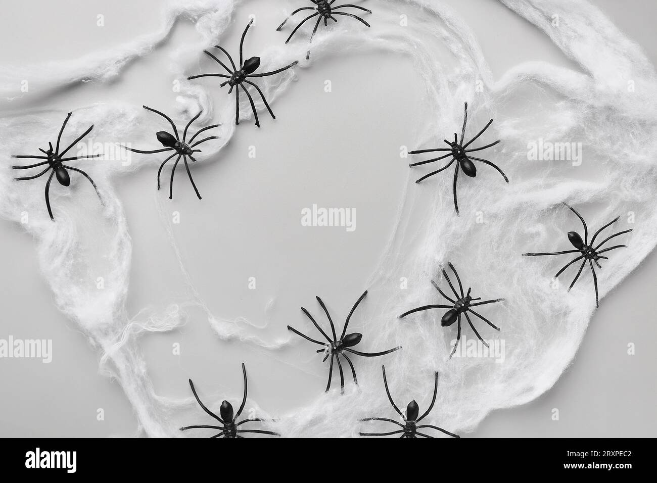 Frame made of cobweb with spiders for Halloween party on grey ...