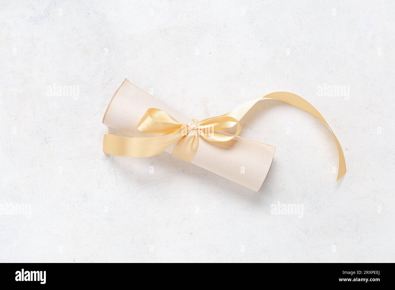 Roll of paper tied with golden ribbon on white background Stock Photo ...