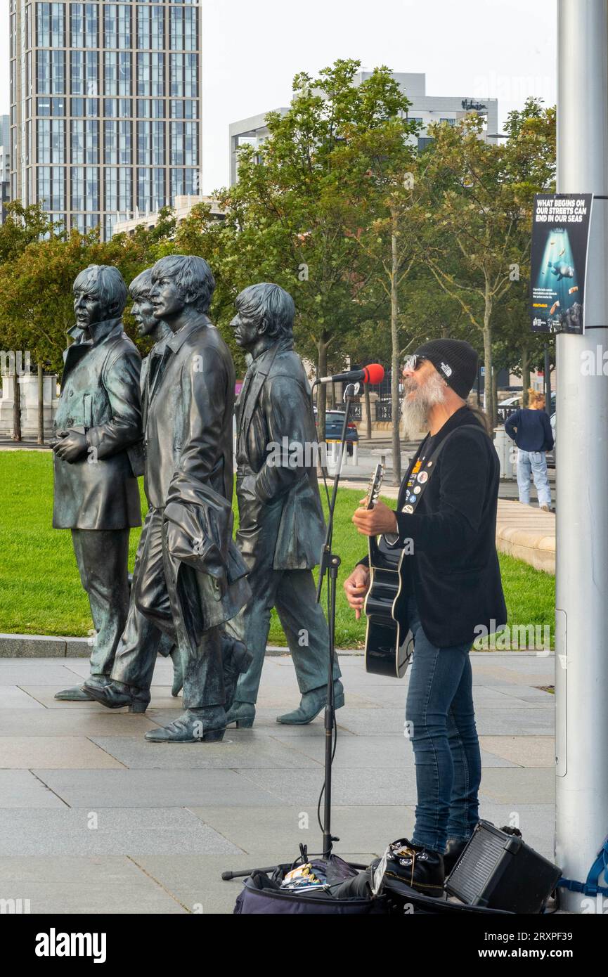 Liverpool busker singing Beatles songs next the the Fab Four statues ...