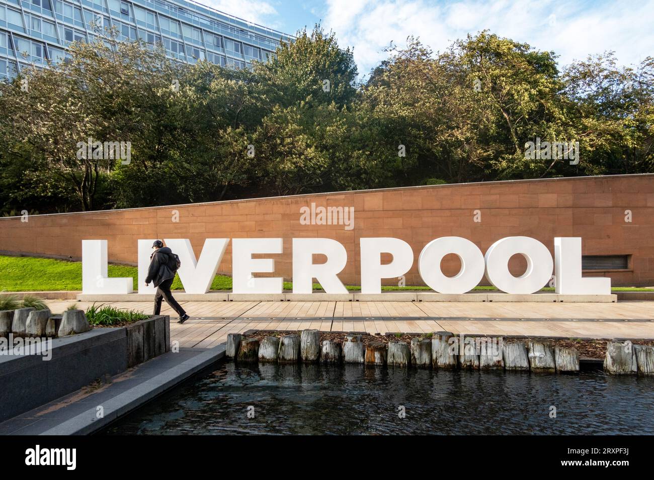 Man walking quickly past Liverpool sign Stock Photo - Alamy