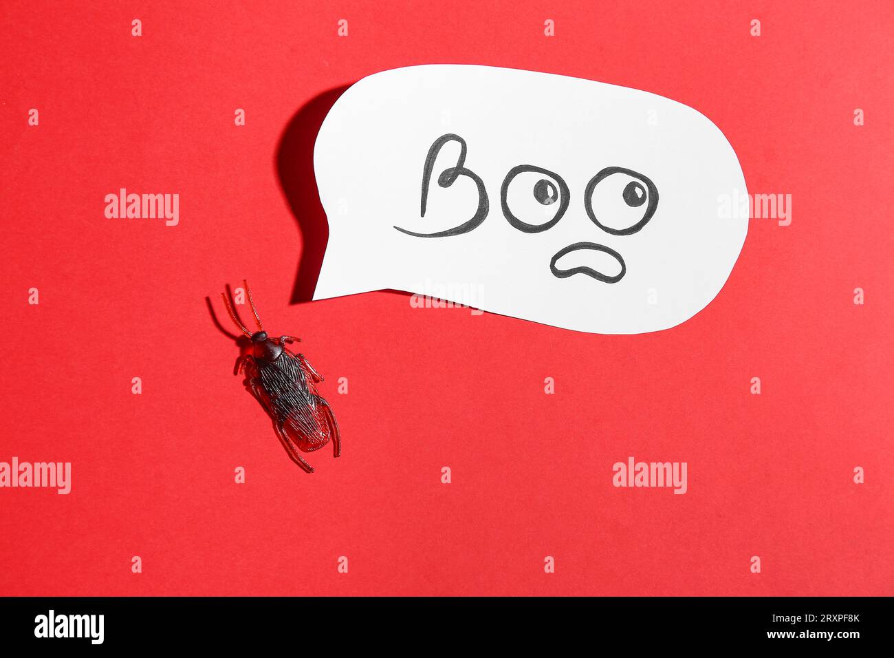 Halloween candy cockroach and speech cloud with text BOO on red ...
