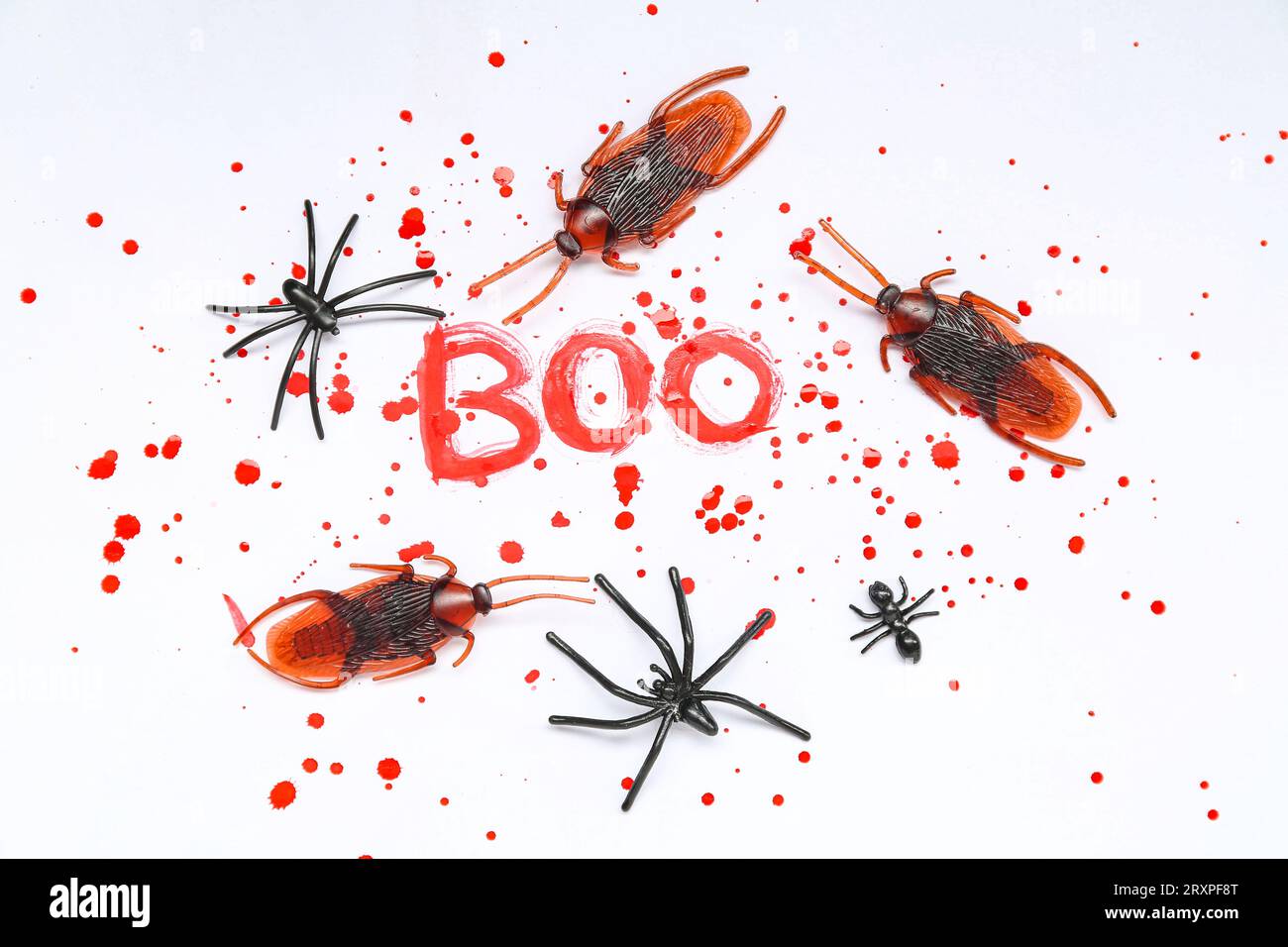 Halloween composition with candy bugs and word BOO made from blood on ...