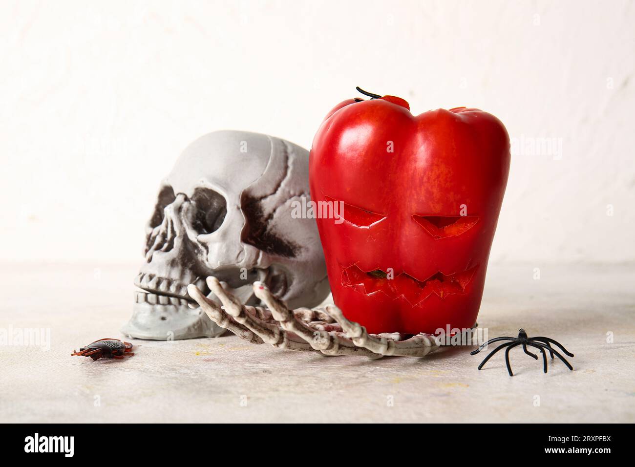 Carved bell pepper for Halloween with skeleton hand, skull and spiders ...