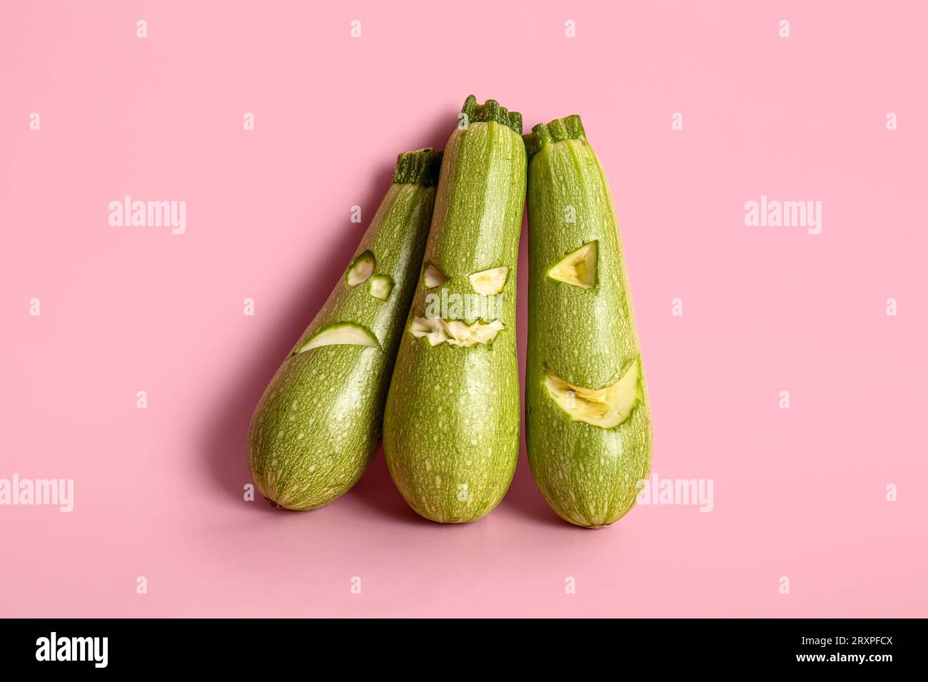 Carved zucchini for Halloween on pink background Stock Photo - Alamy