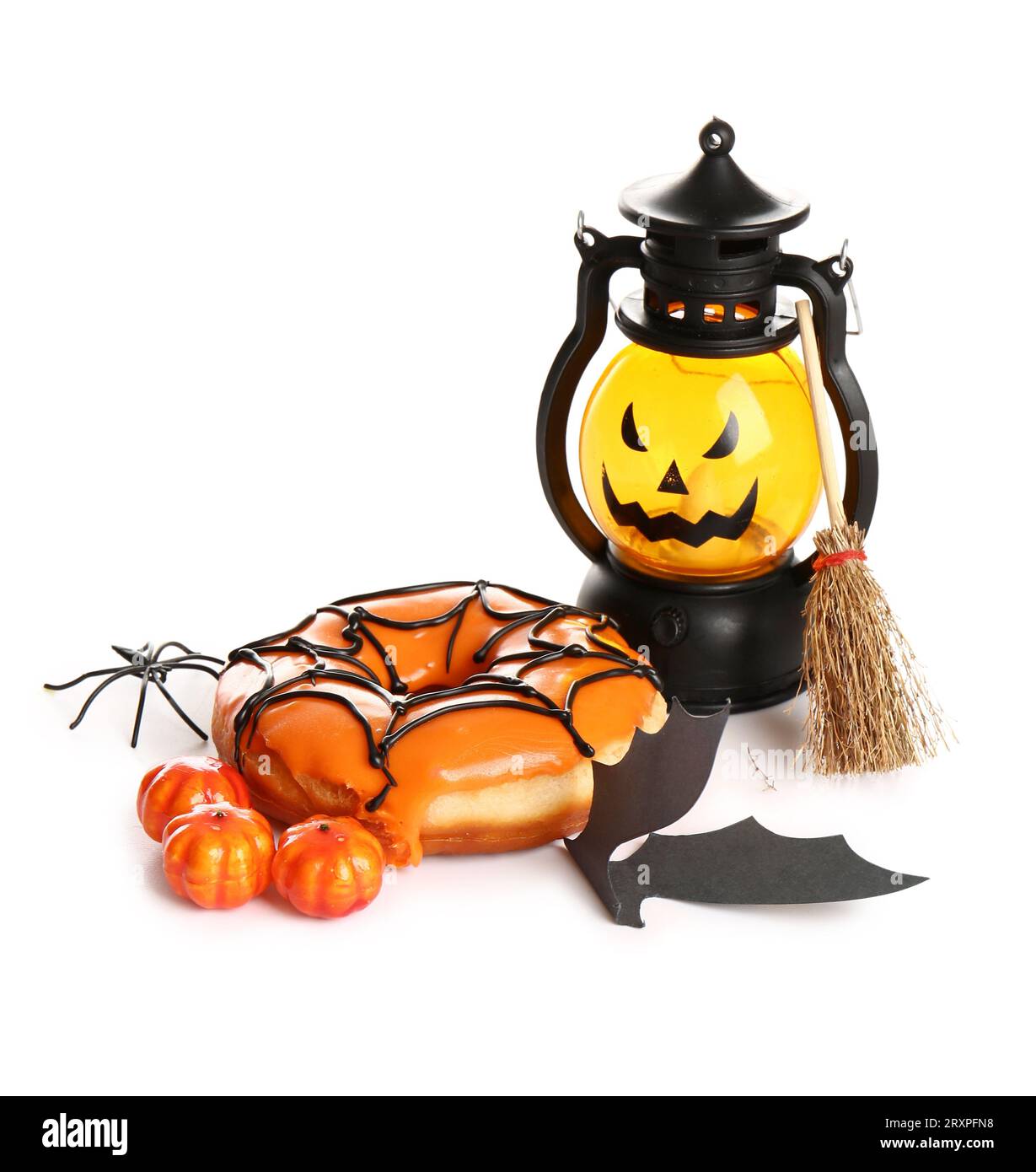 Tasty donut for Halloween with lantern, candies, spider, broom and bat ...