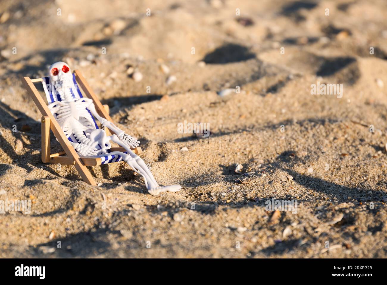Skeleton for Halloween with deck chair on beach Stock Photo - Alamy