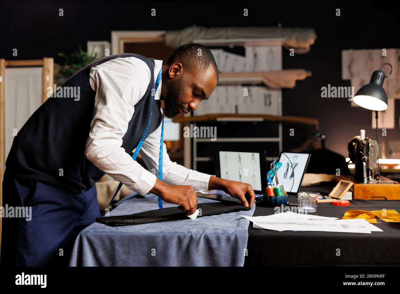 Tailor creating sophisticated suit blazer surrounded by sewing ...