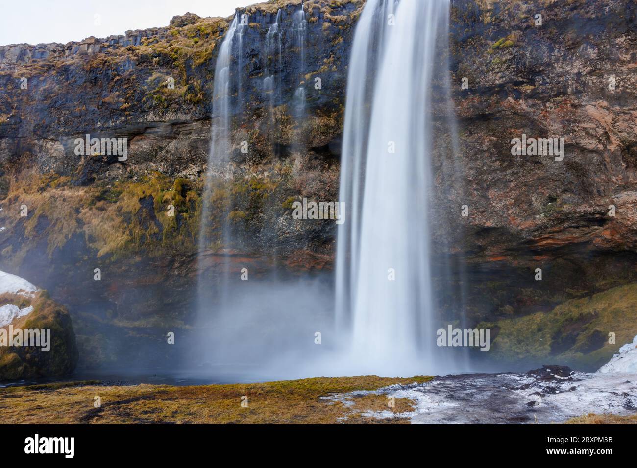 Arctic landscape of icelandic waterfall running down cliff ...