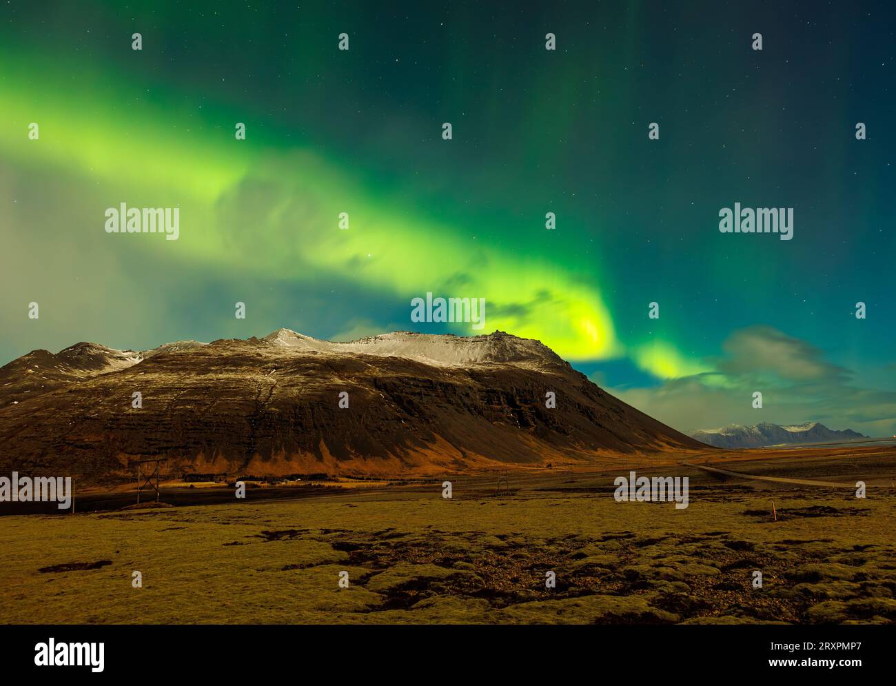 Aurora borealis and massive mountains in Iceland. Glowing northern ...