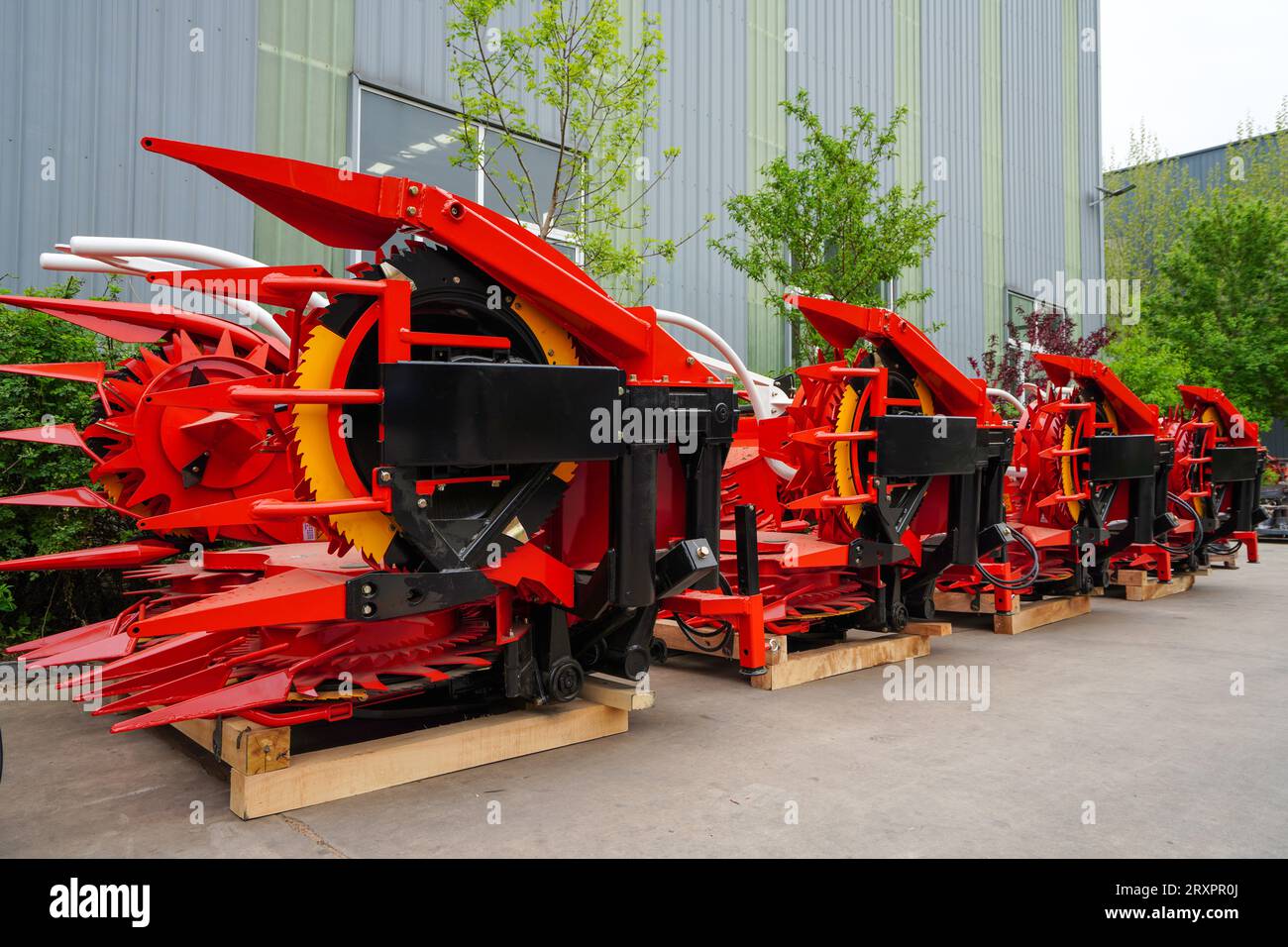 Green feed harvester header stored in the factory area Stock Photo - Alamy