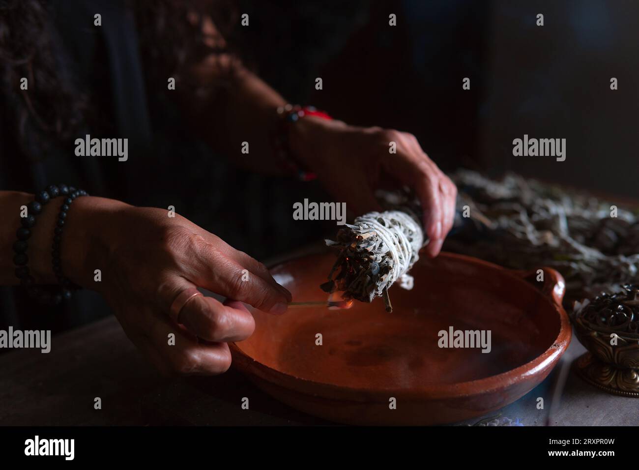 lighting an incense, , witch on the eve of all saints' eve performing a ...