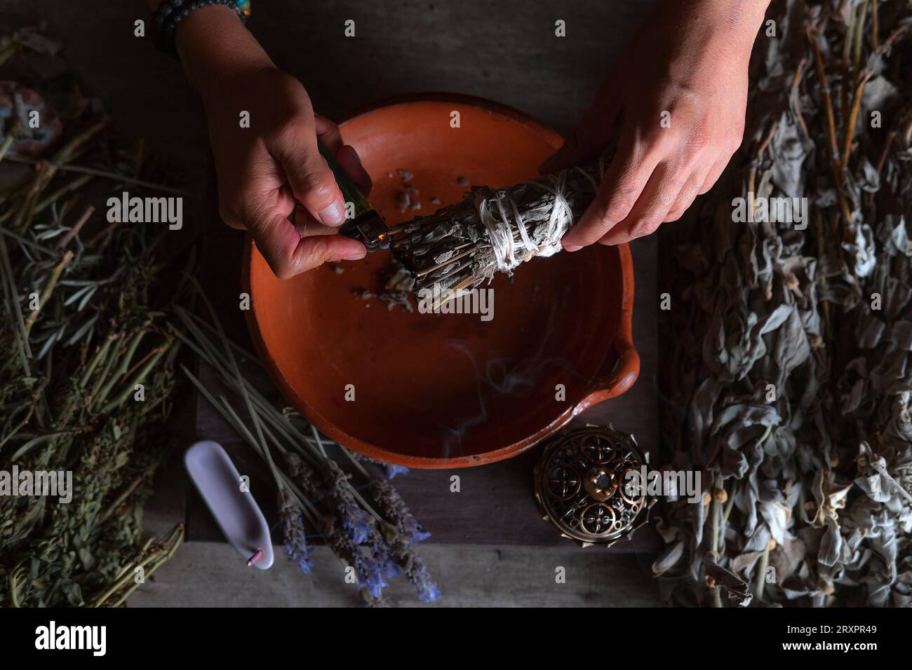 lighting an incense, , witch on the eve of all saints' eve performing a ...