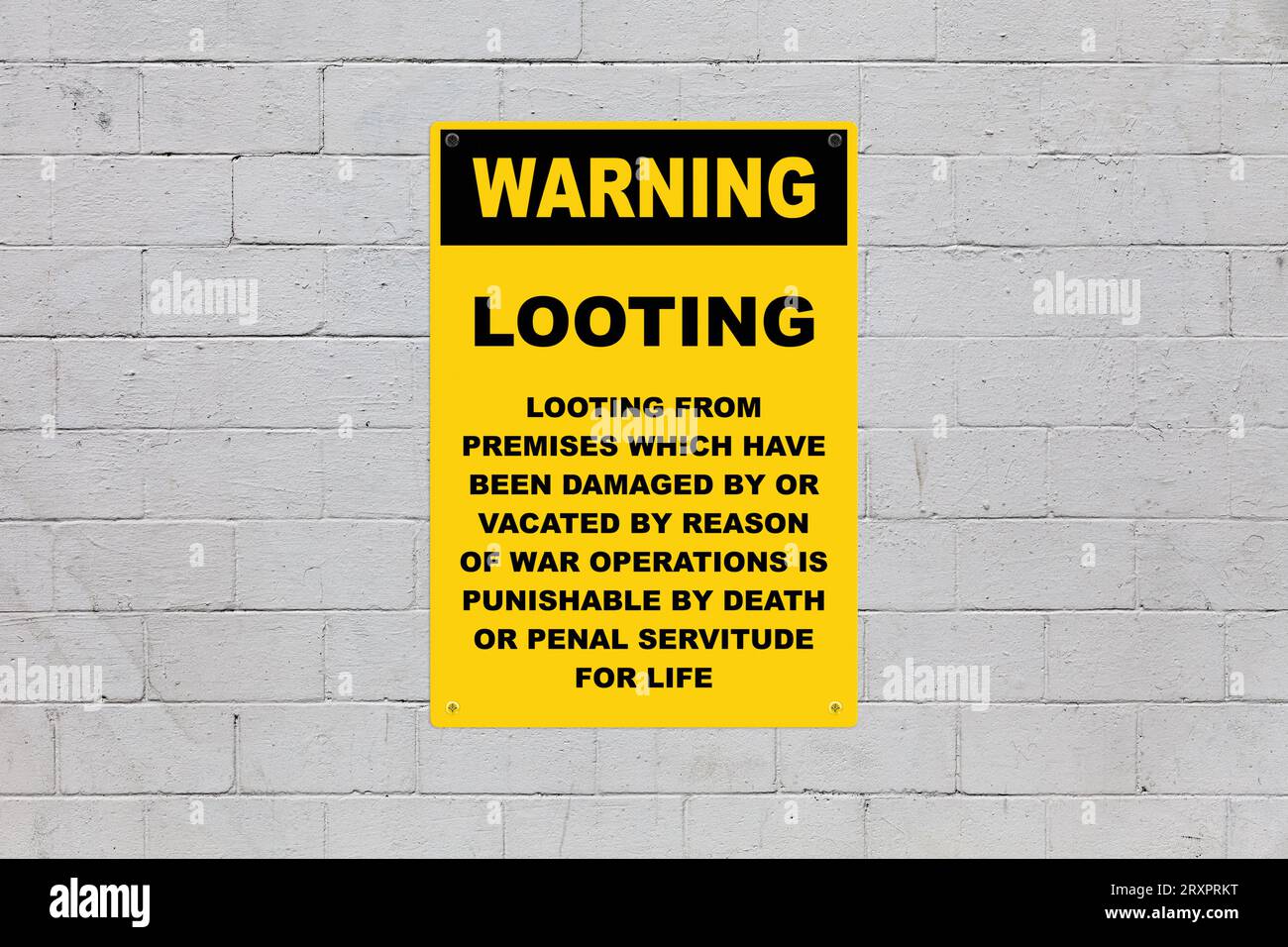 Yellow warning sign screwed to a brick wall to warn about the ...