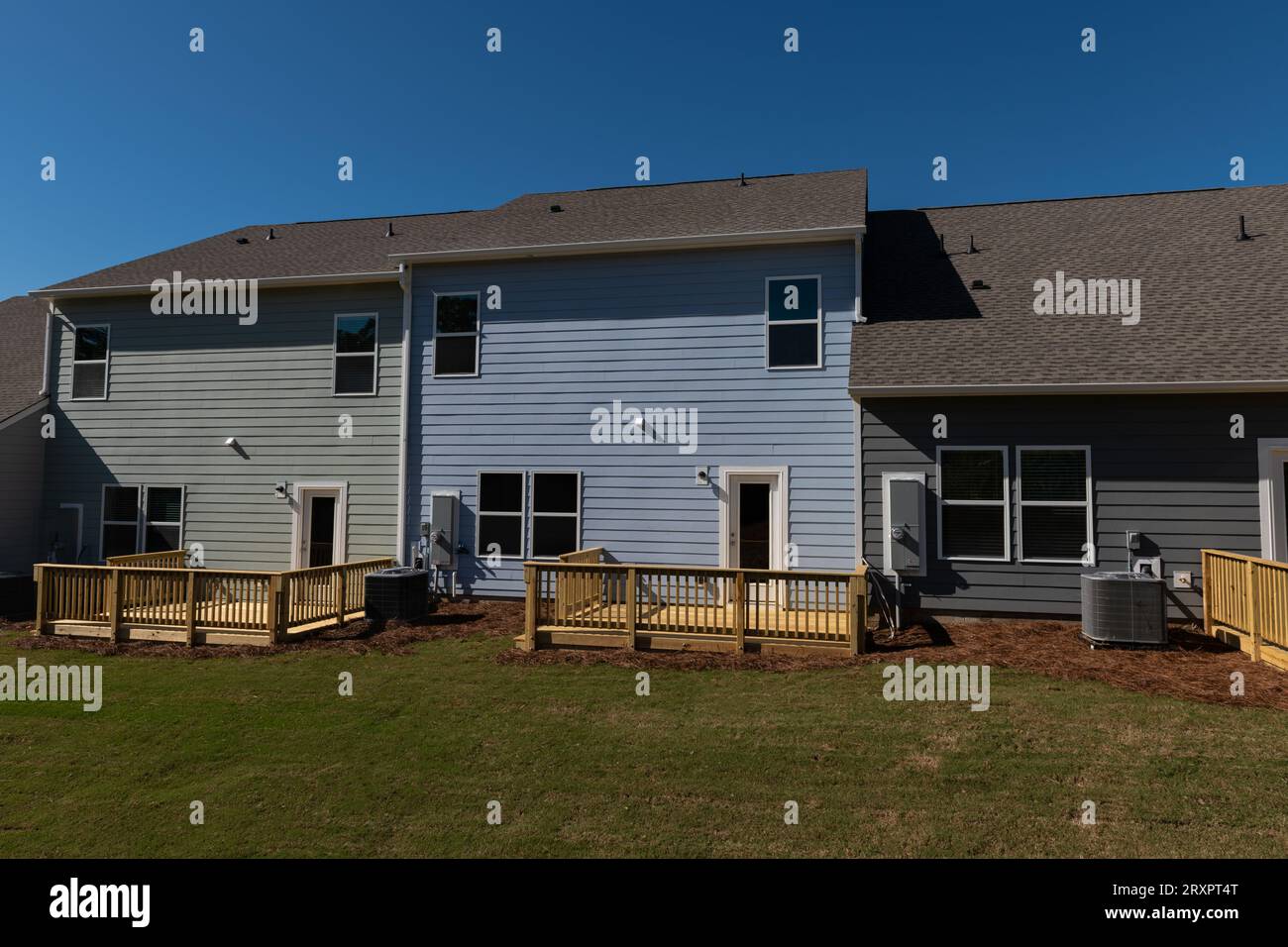 New suburban residential townhomes buildings with back wood decks Stock ...