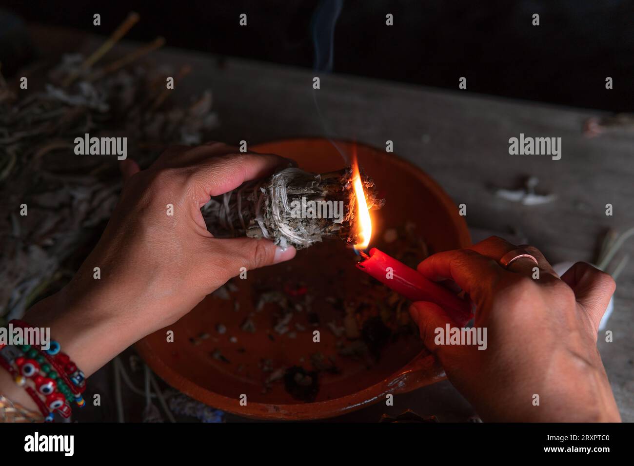 lighting an incense, , witch on the eve of all saints' eve performing a ...