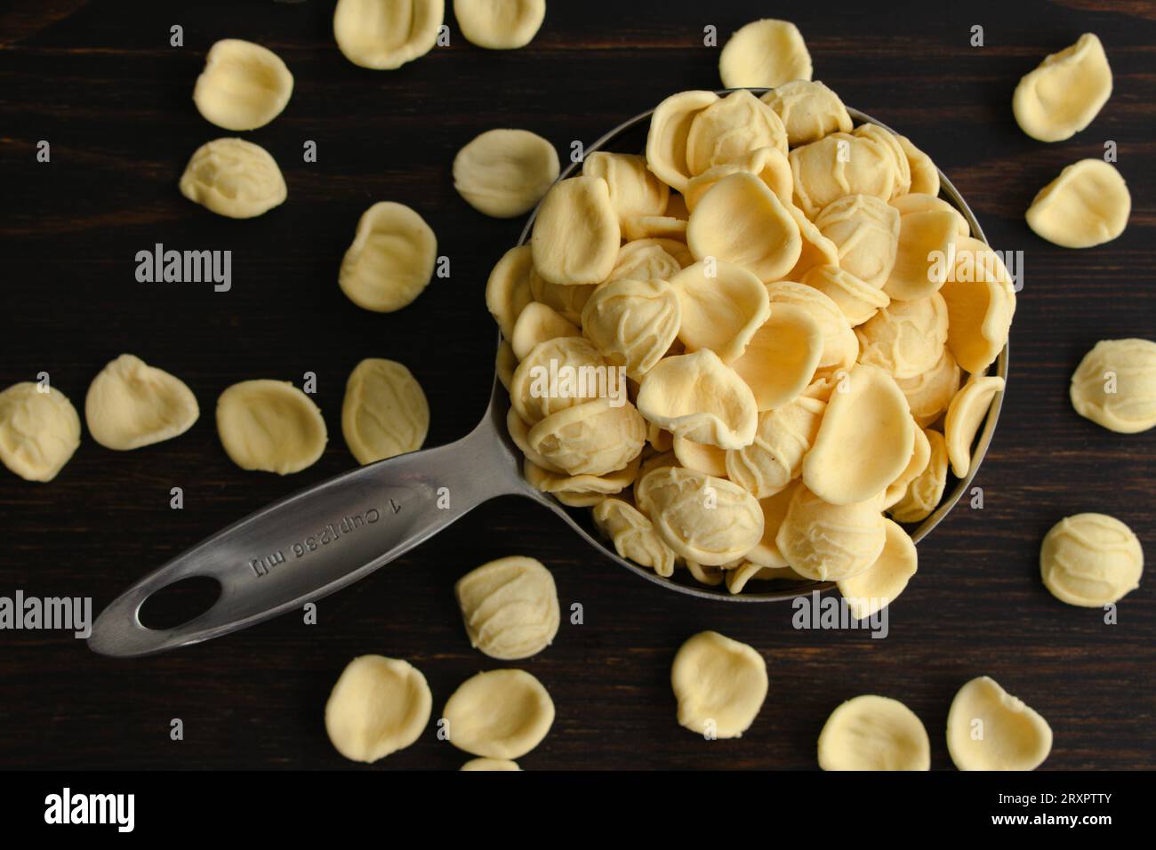Dried Yellow orecchiette Pasta in a Measuring Cup: Uncooked orecchiette ...