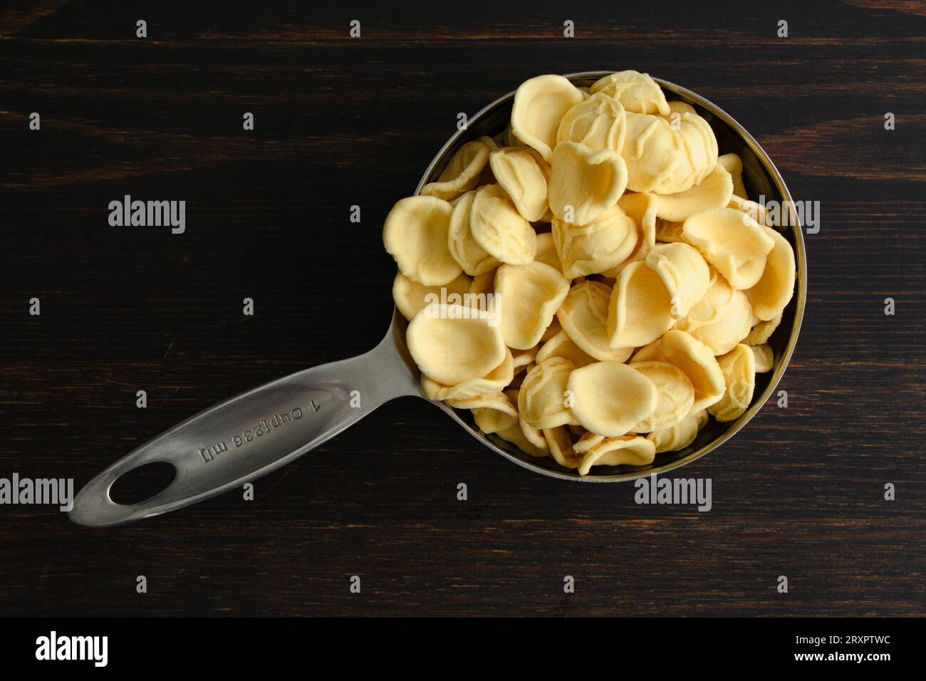Dried Yellow orecchiette Pasta in a Measuring Cup: Uncooked orecchiette ...